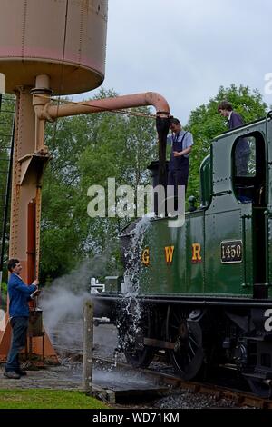 Young volunteer staff refill the water tanks of GWR 14XX class 1450 ...