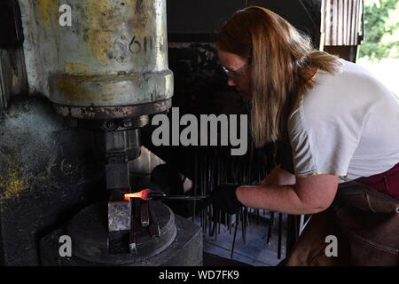 Woman blacksmith working in a forge, Much Hadham, Herfordshire Stock ...