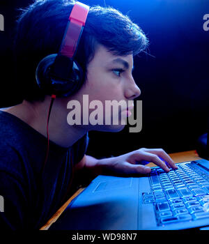 Computer addiction child boy with laptop notebook black background ...