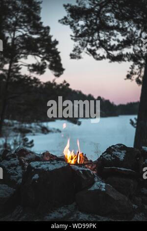 Vertical shot of small bonfire with beautiful flames on the rocks Stock ...