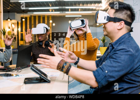 Multiethnic Business team using virtual reality headset in night office ...