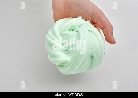 Hand holding slime isolated on white Stock Photo - Alamy