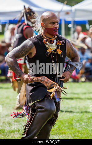 Native American powwow dancer in full traditional regalia at dusk ...