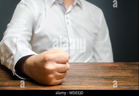 The man hit slammed his fist on the table. The end of patience. It is ...