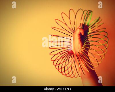 hand and slinky Stock Photo - Alamy