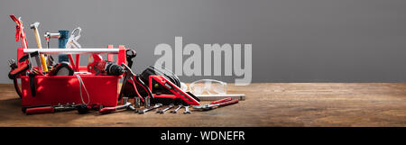 Toolbox with Various Work Tools on Wooden Floor Stock Photo - Alamy