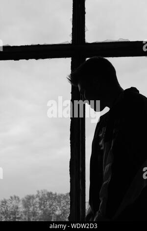 Man looking through broken glass window Stock Photo: 1288821 - Alamy