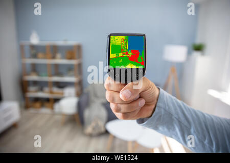 Person Hand Using Infrared Thermal Camera In Living Room Stock Photo ...