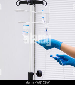 Doctor prepares the system with a dropper and a solution Stock Photo ...