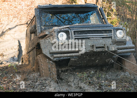 SUV stuck in a rut on a bad impassable road in the woods of Siberia ...