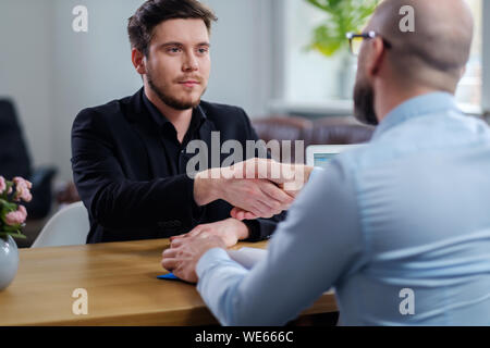 Confident young man attending job interview Stock Photo - Alamy
