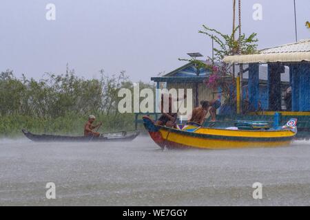 cham community floating house boat village on tonle sap river with phnom penh city skyline in ...