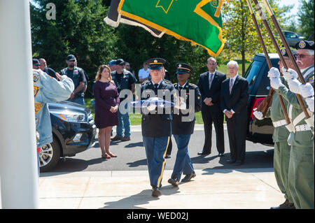 An honor guard arrives with an American flag and the last remains to be ...