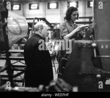 Winston Churchill visits bomb damaged cities. Here he views the shell ...