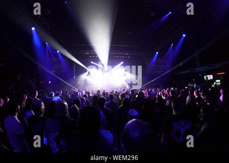 Colourful concert hall with clapping people Stock Photo - Alamy