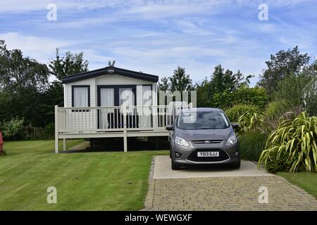 Car and caravan parked on driveway of a house Stock Photo - Alamy