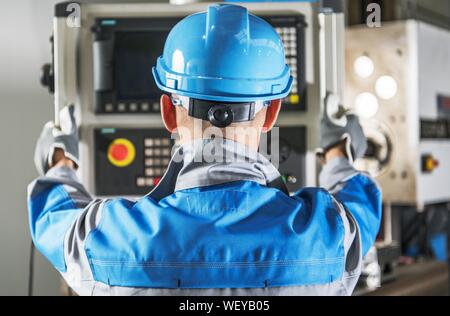 Man working in factory wearing safety helmet and glasses ; india Stock ...