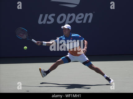 Kei Nishikori, of Japan, returns a shot against Lloyd Harris, of South ...