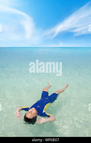 Boy floating on his back in the sea Stock Photo: 86743983 - Alamy
