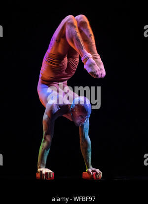 An artist performs during a performance of Humans by contemporary ...