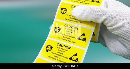 Hand holding ESD symbol label with antistatic gloves,Electrostatic ...