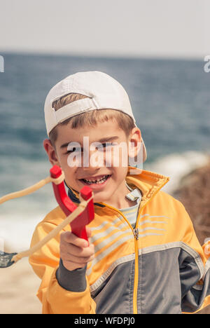 Smiling boy holding a toy Stock Photo - Alamy