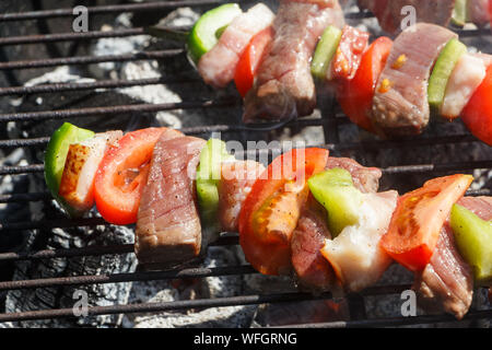 Beef brochettes grilling on the grid of a barbecue Stock Photo - Alamy