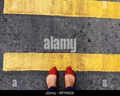 Double red line road markings on a UK road Stock Photo - Alamy