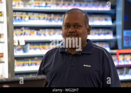 Cashier behind cash register in cafe Stock Photo - Alamy