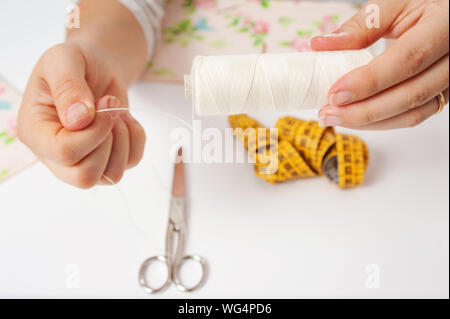 hand holding needle and thread Stock Photo - Alamy
