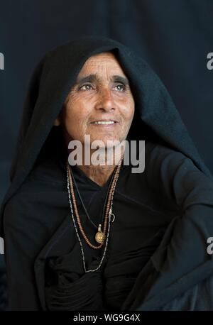 India, Gujarat, Kutch. A Rabari woman sits at Than Monastery. Rabari ...