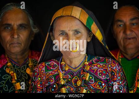 Elderly Ahir woman in traditional colorful cloth with a nose ring ...