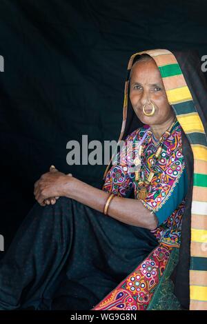 Elderly Ahir Woman in traditional colorful cloth with a nose ring ...