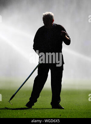 Grounds staff tend to the pitch during the Premier League match at ...