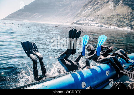 Scuba diver jumping into the water from a dive boat.Coastal waters ...