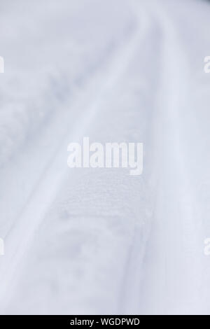 Closeup of long ski tracks in deep white snow at winter Stock Photo - Alamy