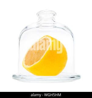 side view of half of yellow lemon in Glass Lemon Keeper isolated on ...