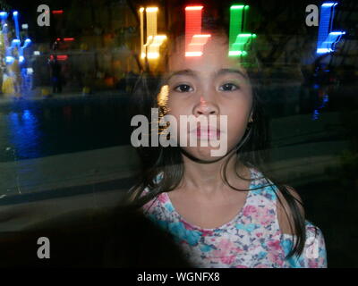Girl at night with window reflection Stock Photo - Alamy