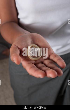 Woman holding a condom Stock Photo - Alamy