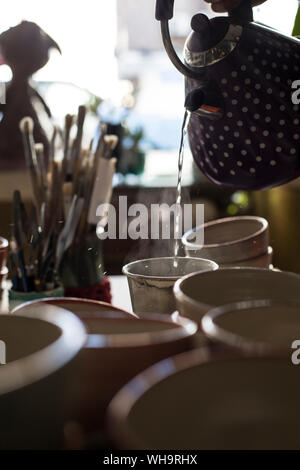 Pouring water in cooking pot Stock Photo - Alamy