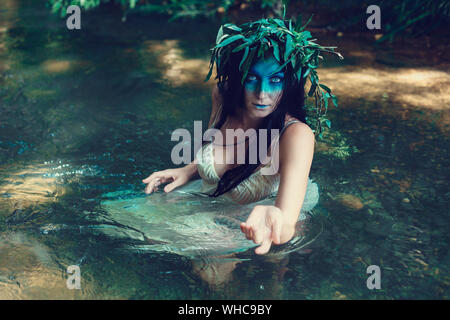 Young drown woman in a poetic representation. The concept of the undead ...