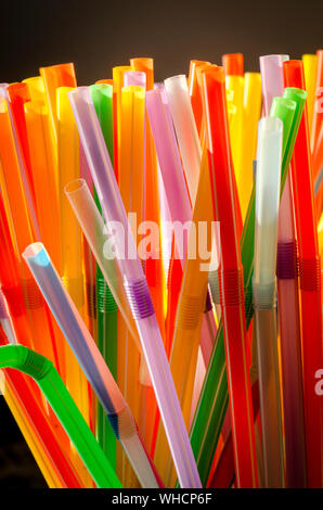 Bunch of colored plastic straws isolated on white background close up ...