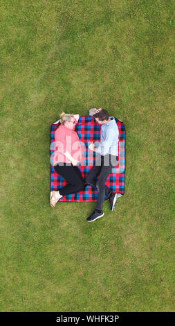 Drone aerial view of relax woman in dress lying on flower blooming ...