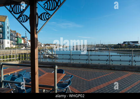 Littlehampton harbour at low tide looking towards the open sea, West ...