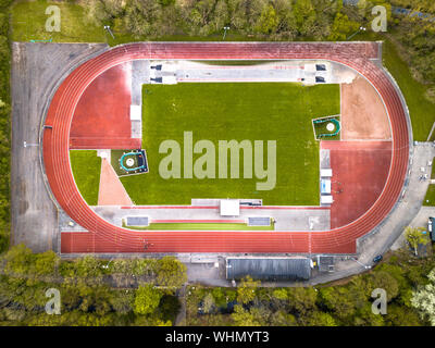 Aerial view of a red athletics running track and field. This one at ...