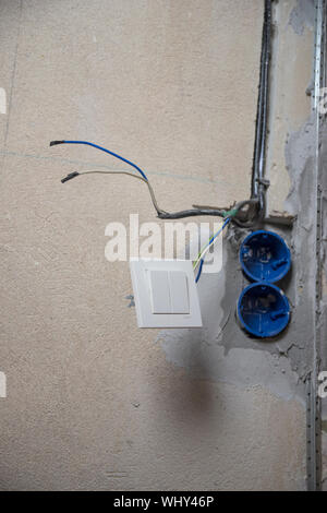 Replacing the electrical outlet in the wall of the house Stock Photo ...