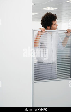 Man Peeking Over Cubicle Wall Stock Photo - Alamy