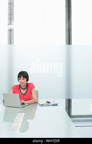 Working in her cubicle. an attractive young woman standing in her office cubicle Stock Photo - Alamy