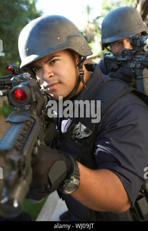 Two Multiethnic Police Officers Aim at a Suspect. Police Using a Weapon ...