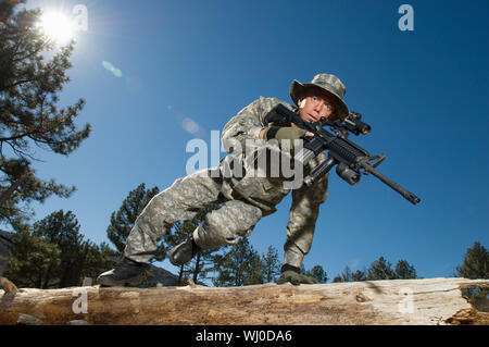 Soldier jumping over log Stock Photo - Alamy